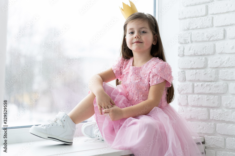 Cute little girl in a princess costume. Pretty child preparing for a ...