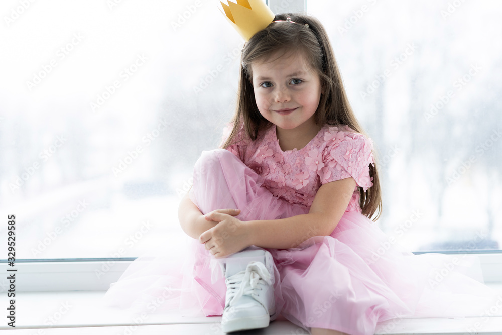 Cute little girl in a princess costume. Pretty child preparing for a ...