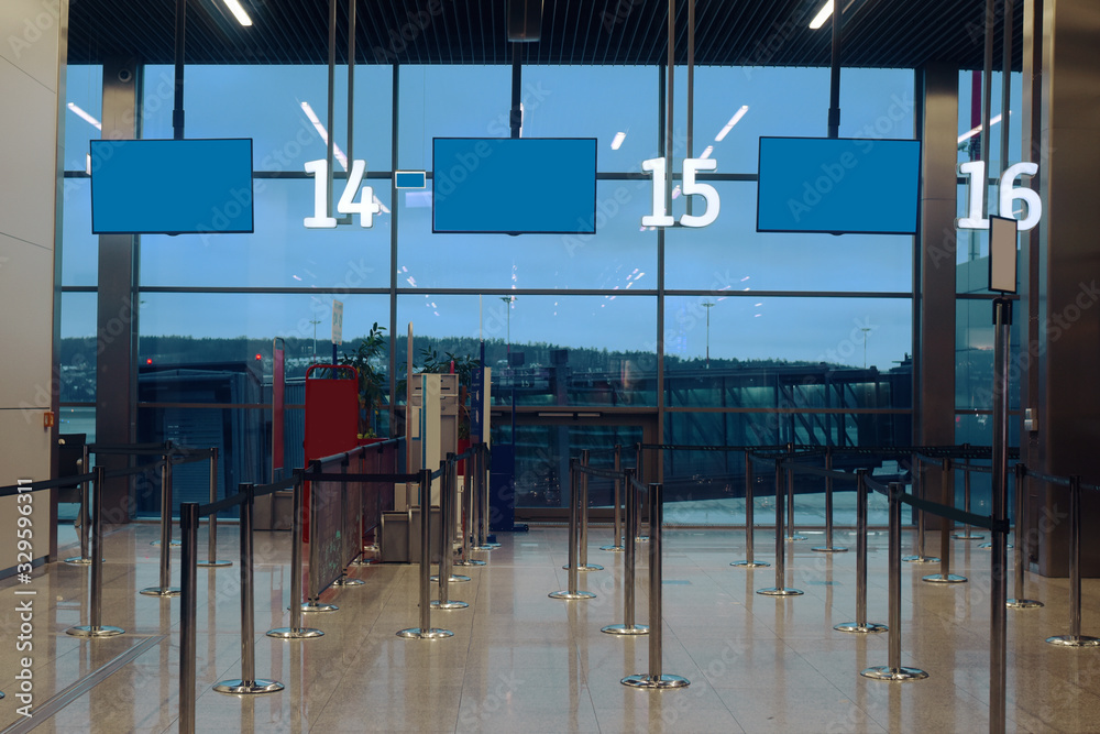 Airport front desk. TVs with a green screen. Advertising at the airport ...
