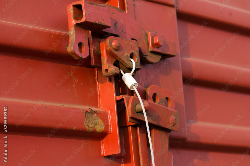 Red railway freight car with The lock on a door with a metal seal ...