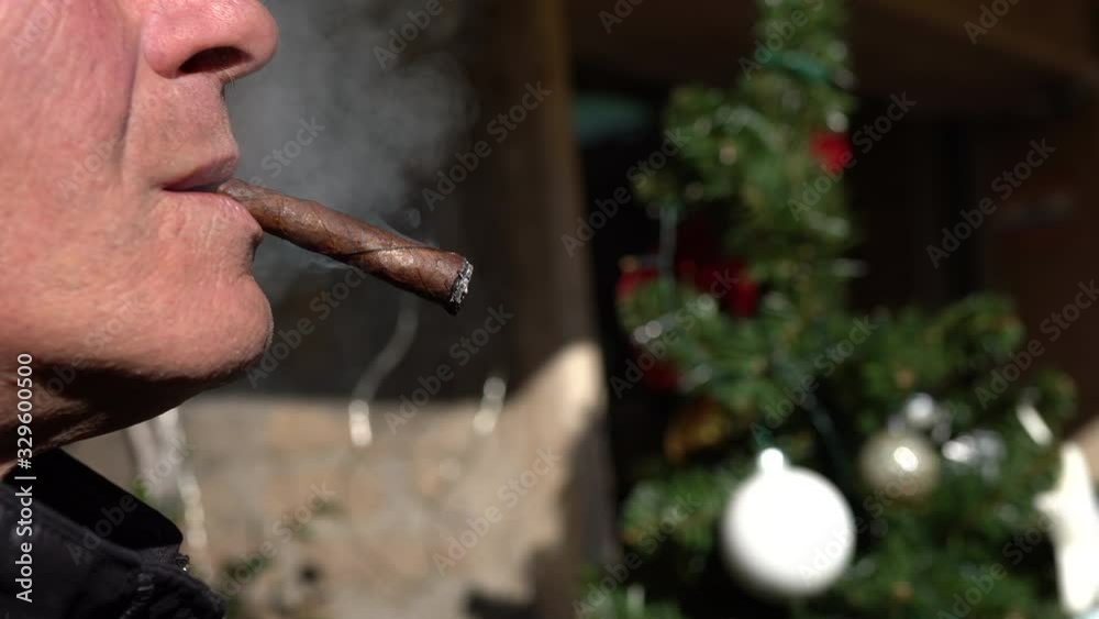 Dangerous mafia gangster smoking expensive cuba cigar outdoors, side ...