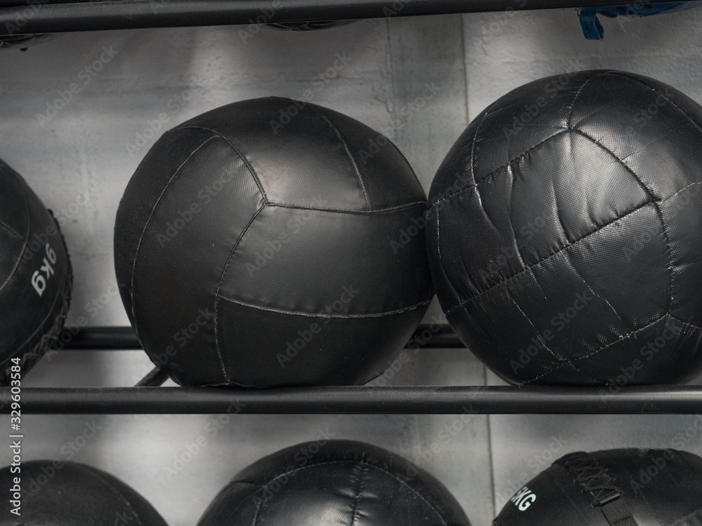 Black heavy balls in a gym Stock Photo | Adobe Stock
