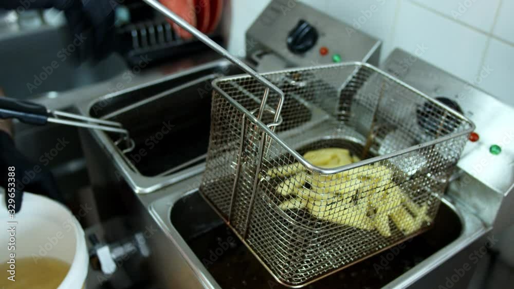 French fries fast food restaurant. Close up slow motion of deep fry ...