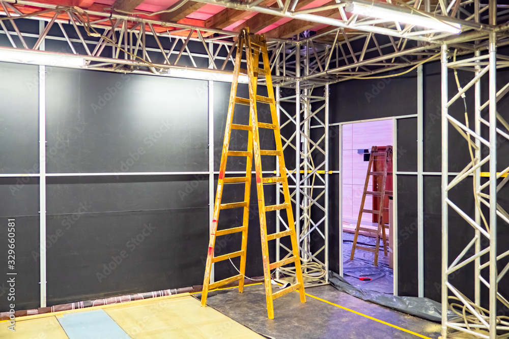 Building ladder near the exit. Door in a temporary room. Preparing a ...