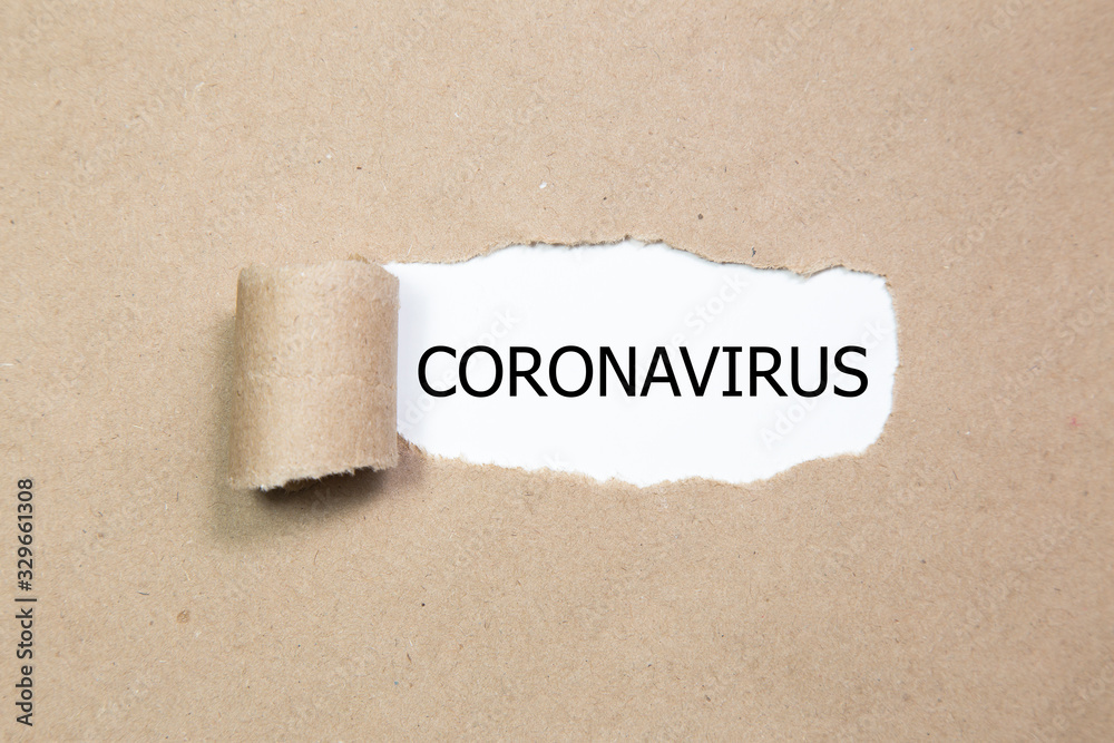 The word CORONAVIRUS appearing behind torn paper Stock Photo | Adobe Stock