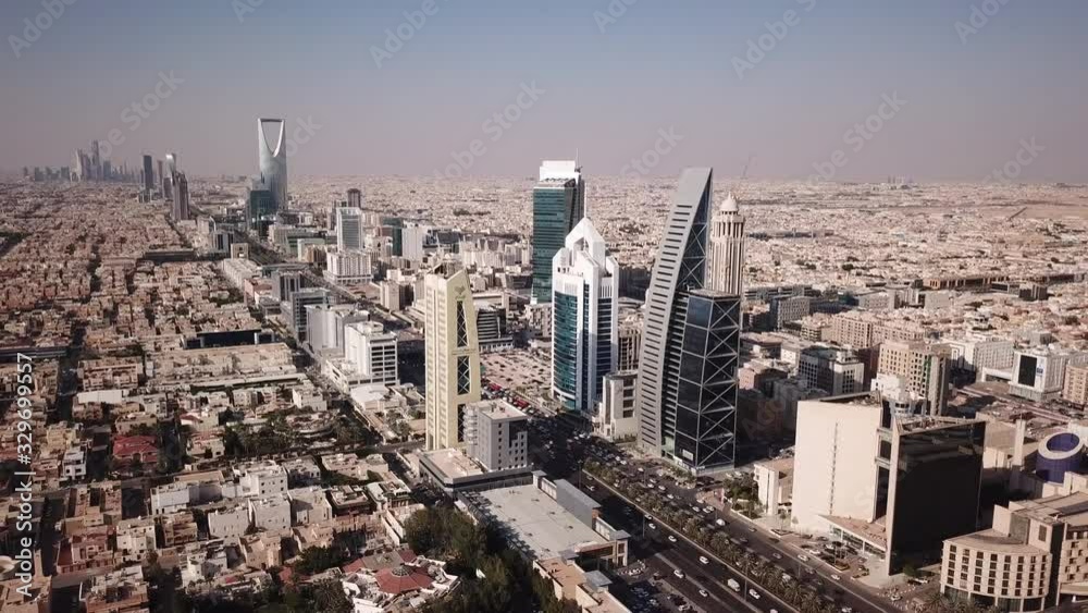 Retreating aerial footage of modern skyline of office towers and low ...