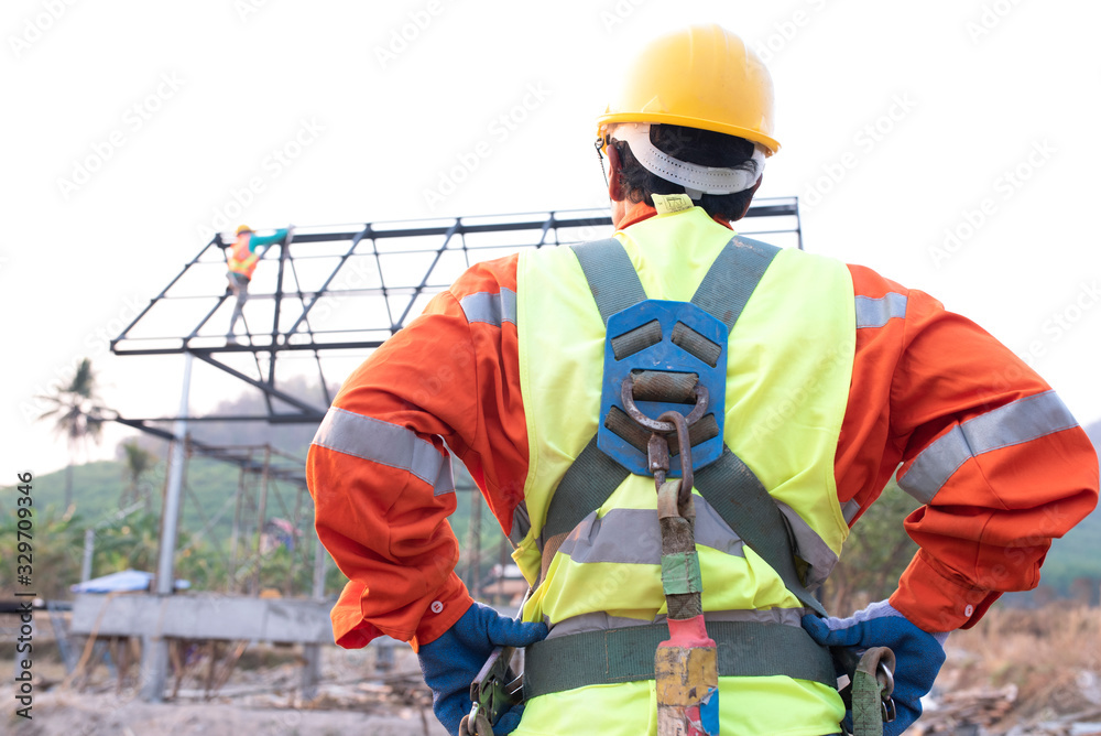 Construction team engineers wear steel roof safety inspection uniforms ...