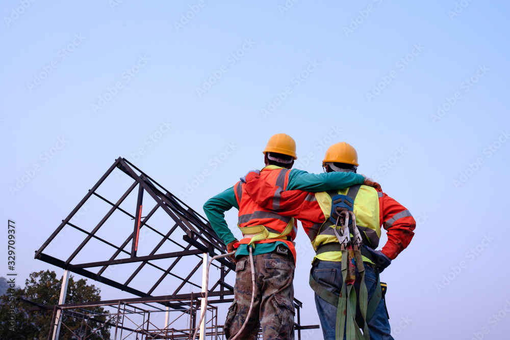 Construction team engineers wear steel roof safety inspection uniforms ...
