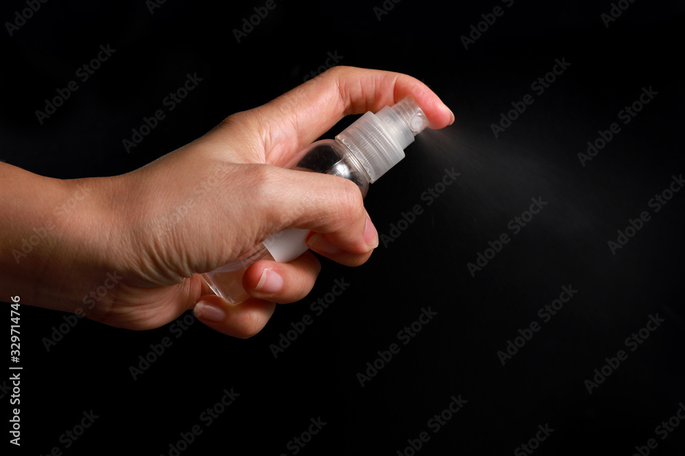 Hand of lady that applying alcohol spray or anti bacteria spray to ...