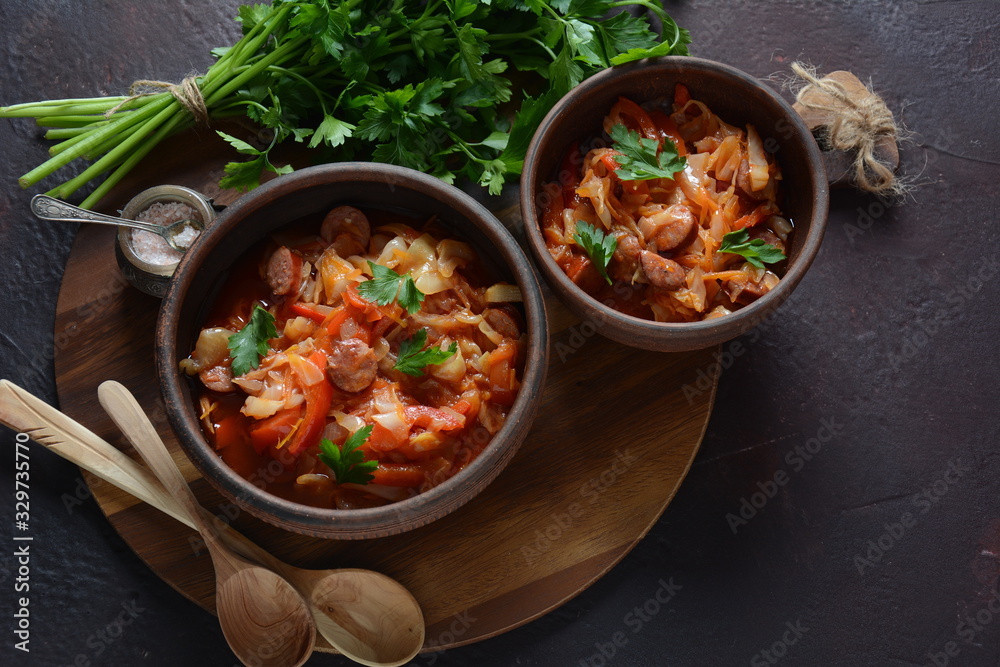 Cabbage stew with grilled sausage in tomato sauce - traditional dish of ...