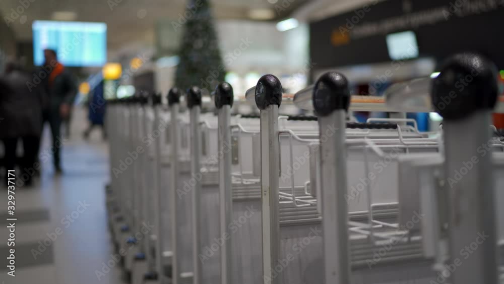 Vídeo do Stock: Row of empty luggage carts at airport terminal, airport ...