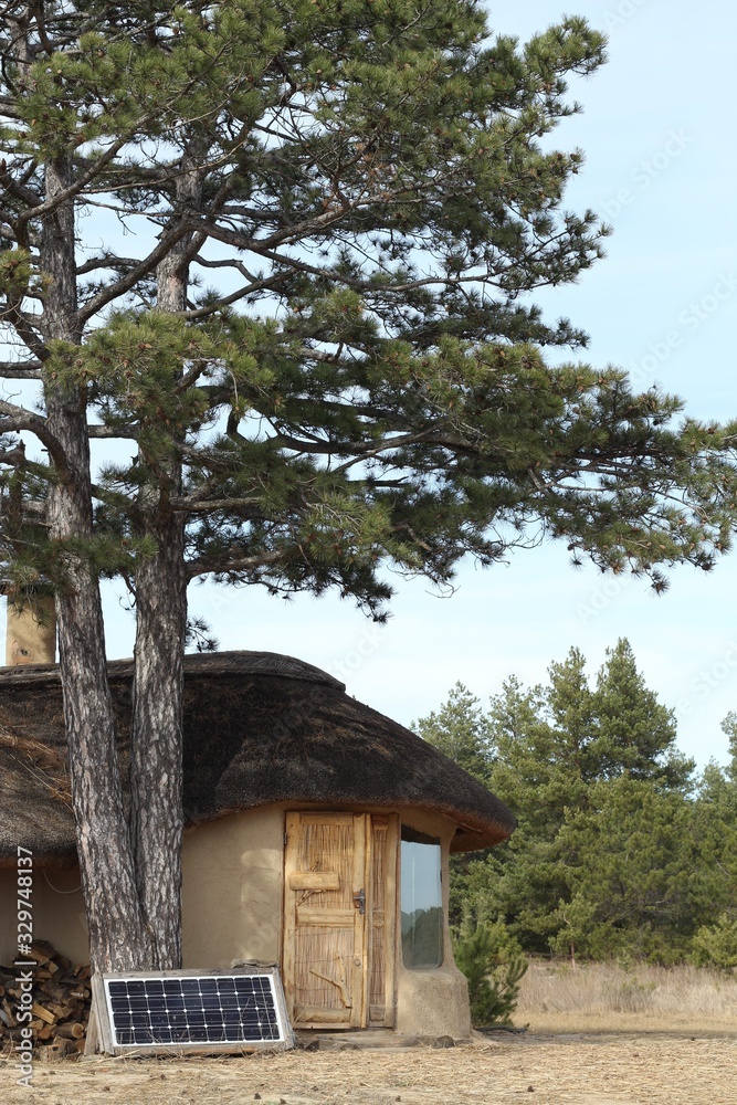 clay house and solar panels, ecological house, natural materials for ...