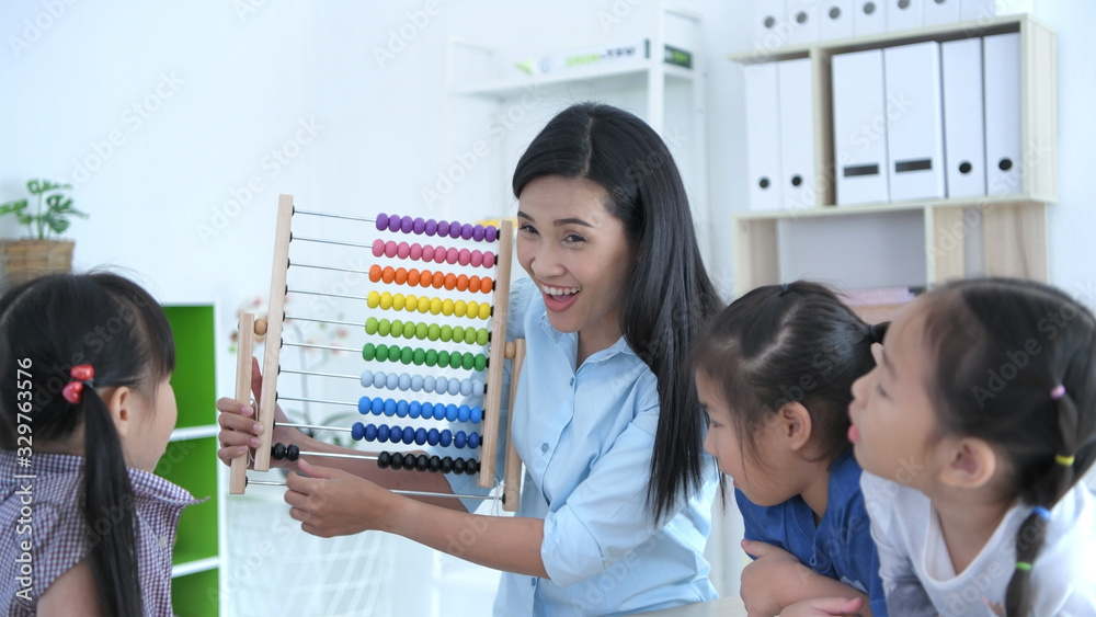 Educational concepts. The teacher is teaching math with abacus for ...