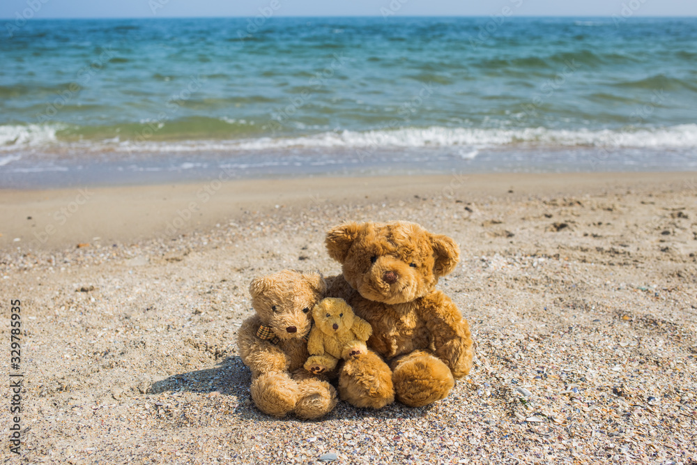 Happy family on summer vacation at seaside concept. 3 cute brown teddy ...