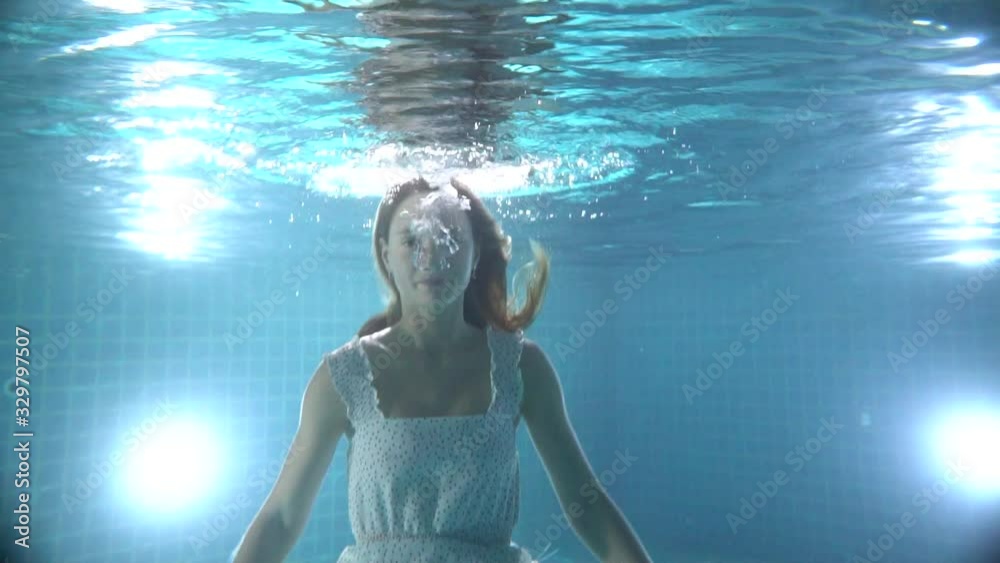 Beautiful woman with long red hair swimming underwater in dress - video ...