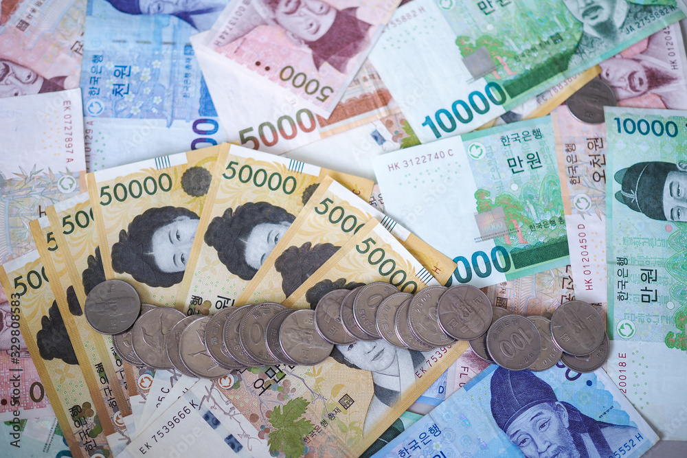 Korean won currency. Various types of bank notes and coins lined up ...