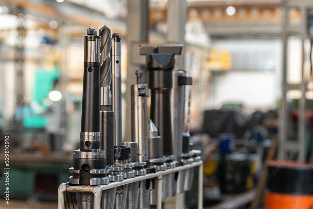 Conical and collet mandrels with cutters and drills on the rack ...