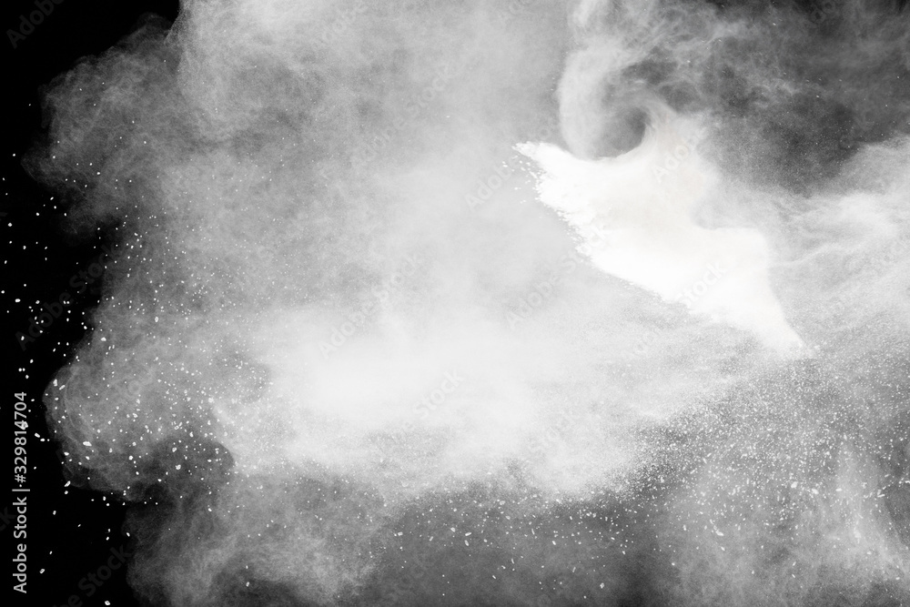 Freeze motion of white dust particles splash on black background.White ...