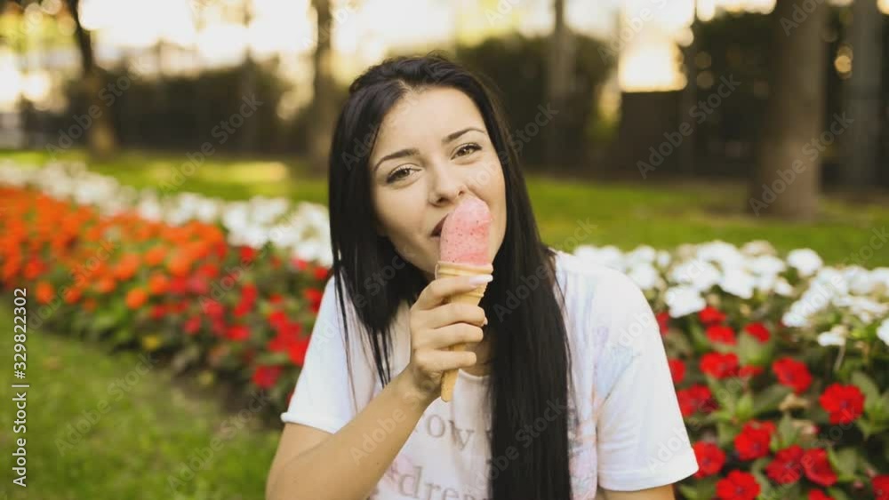 Vídeo do Stock: Young beauty woman is eating ice cream in HD VIDEO. She ...