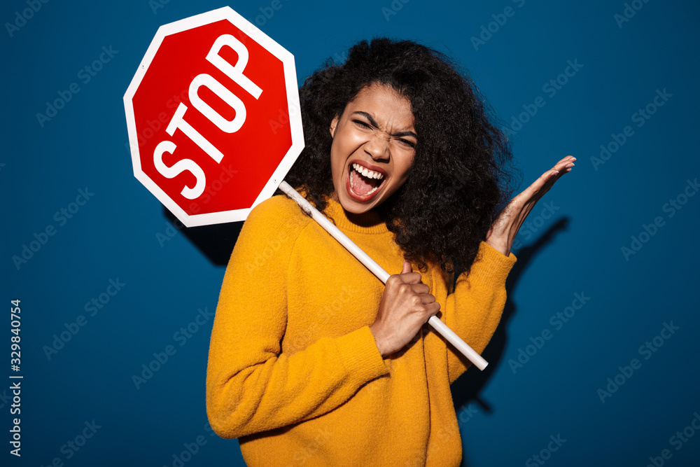 Displeased african woman holding stop symbol sign. Stock Photo | Adobe ...