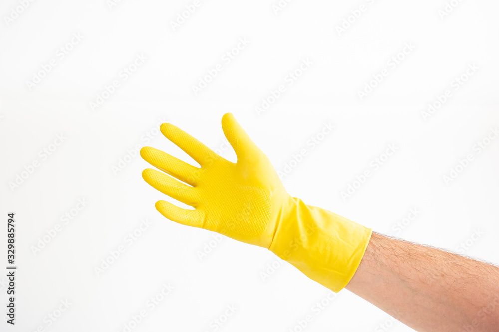 White Caucasian male hand with yellow latex glove open palm against ...