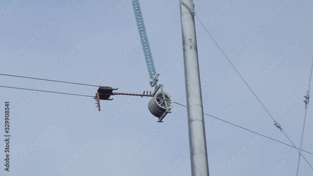 pulling of high-voltage line wire through power transmission towers ...