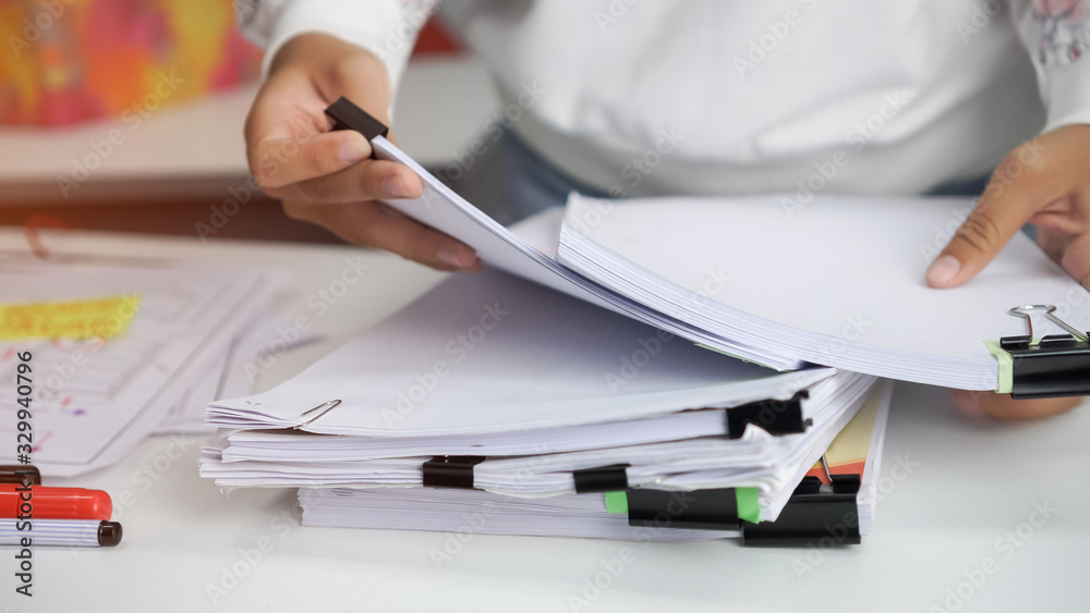 Businesswoman hands working in stacks of paperwork files for searching ...