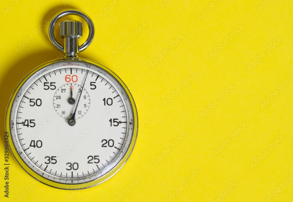 Classic stopwatch on a yellow background Stock Photo | Adobe Stock