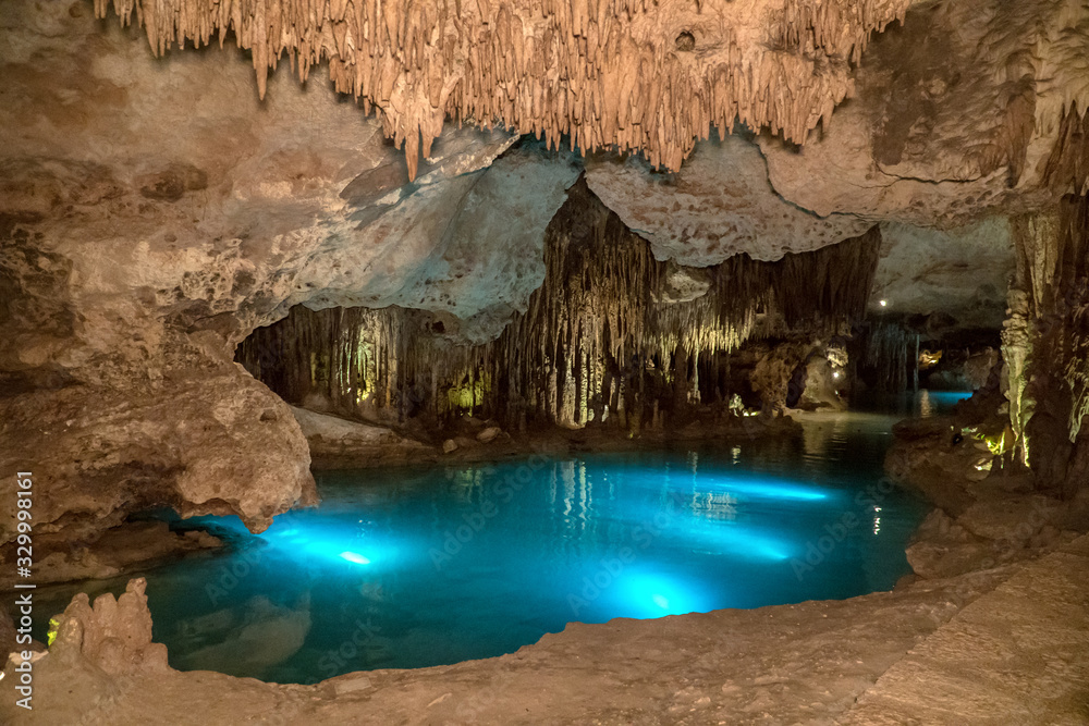 Amazing underground limestone caves. Blue river is under light. Mexican ...