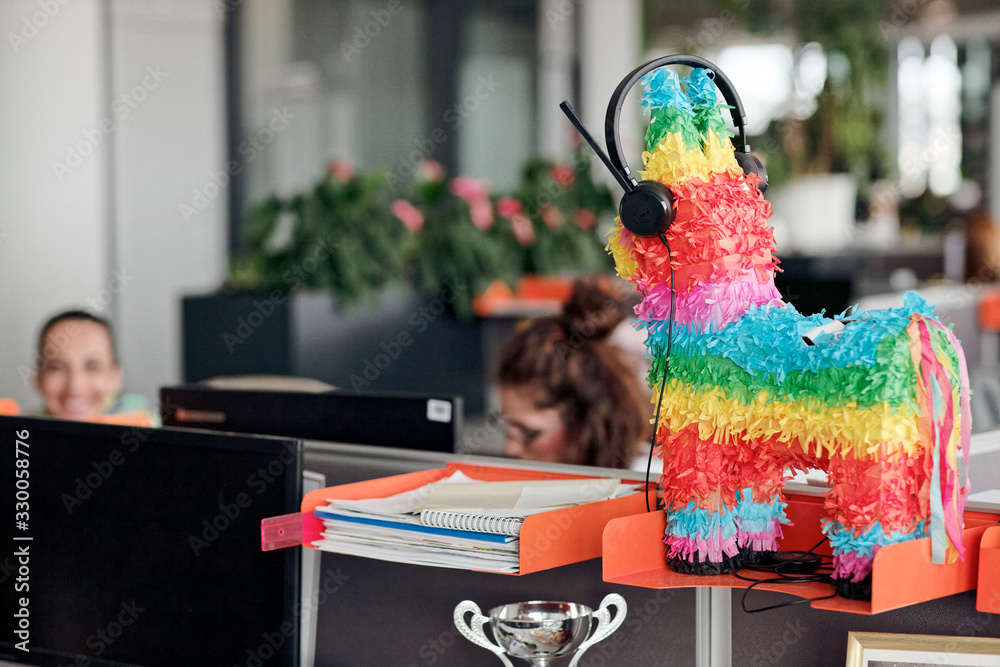 Donkey pinata in openspace office wearing callcenter headphones Stock ...
