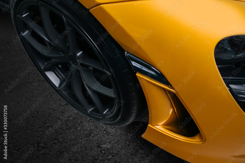 Front wheel of supercar close up Stock Photo | Adobe Stock