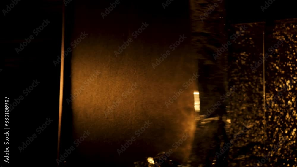 Close up of rotating panel wrapped in foil under the golden spotlight ...