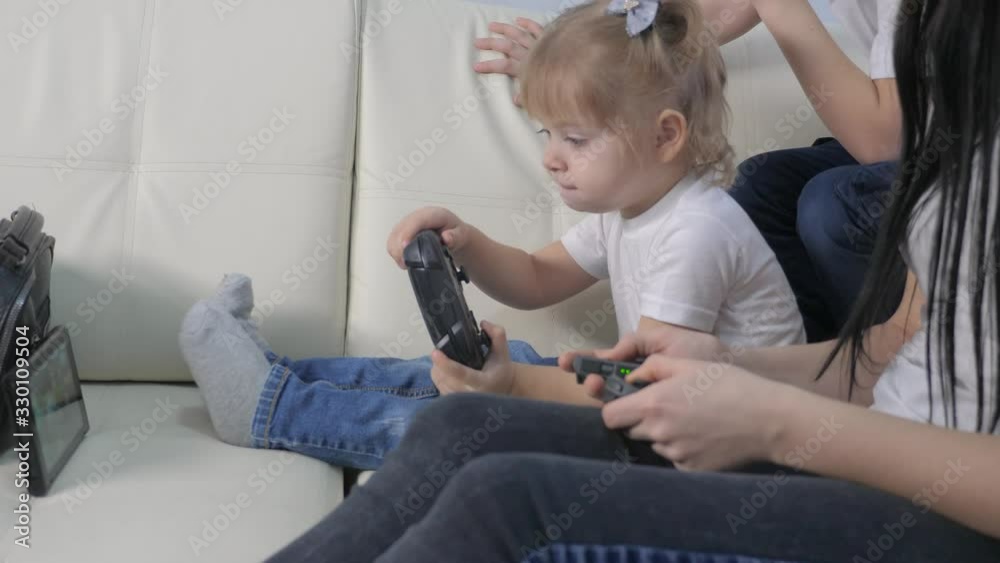 mother and children play console in gamepads teamwork. mom and kids a ...