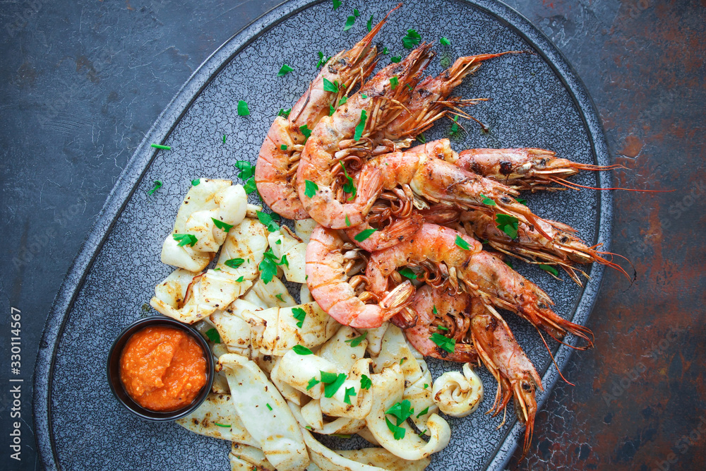 Plate with seafood, King prawns and squid, Fish menu in the restaurant ...