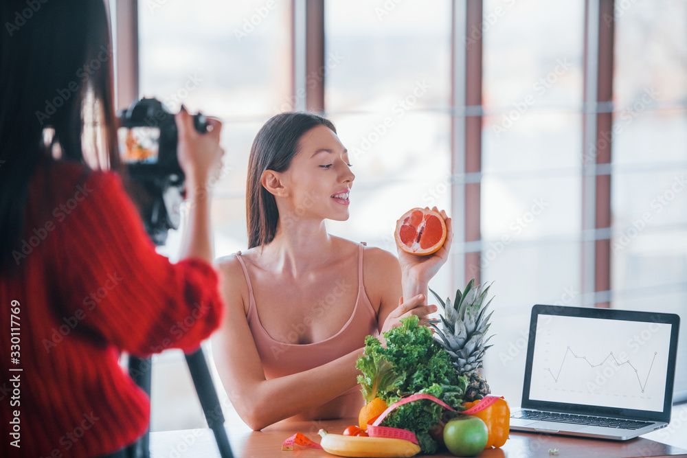 Fitness model have photoshoot by female photographer indoors by the ...