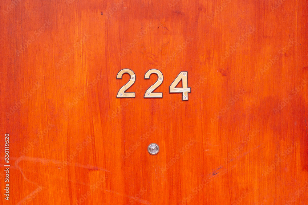 House number 224 on a varnished wooden front door Stock Photo | Adobe Stock