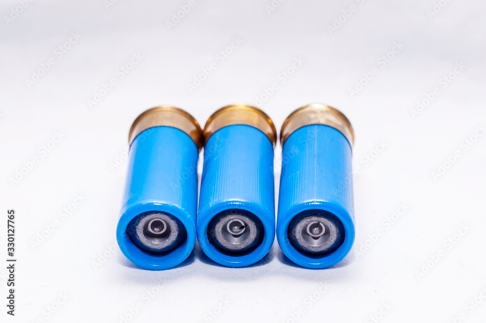 Three blue 12 gauge rifled shot gun slugs on a white background Stock ...