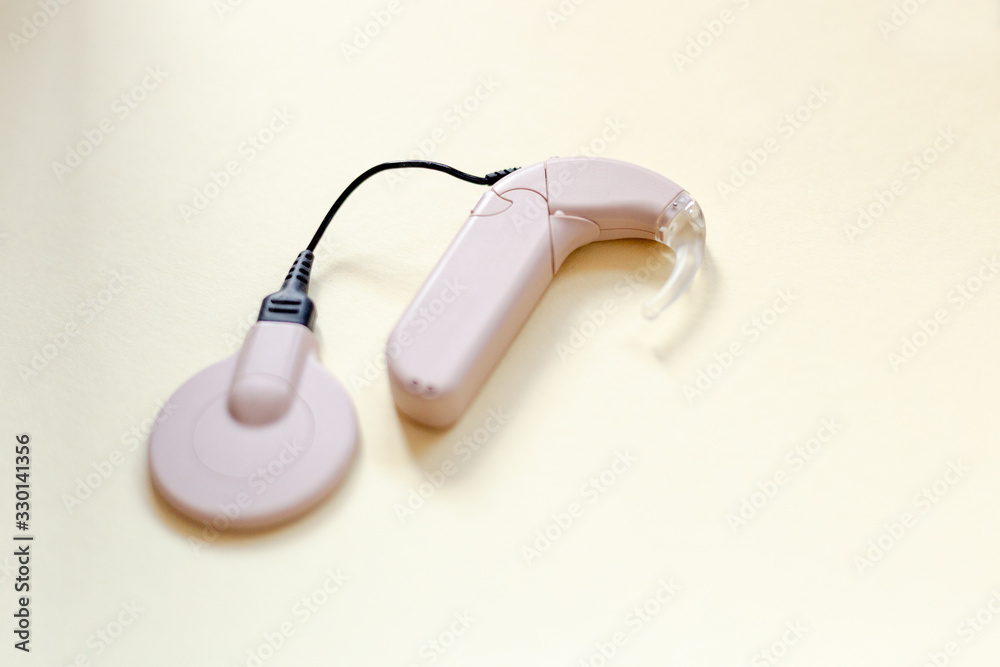 cochlear implant on the arm. hearing aid Stock Photo | Adobe Stock