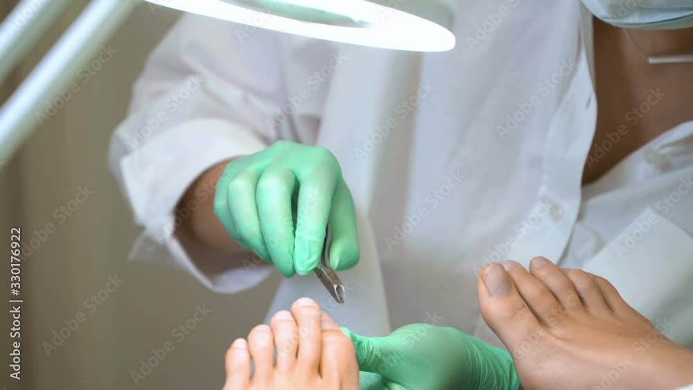 Pedicure master making aesthetic pedicure in a beauty salon. A ...