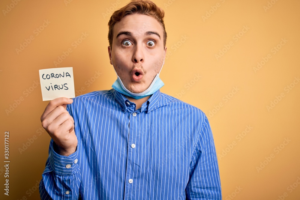 Young man wearing medical security mas holding paper note reminder with ...