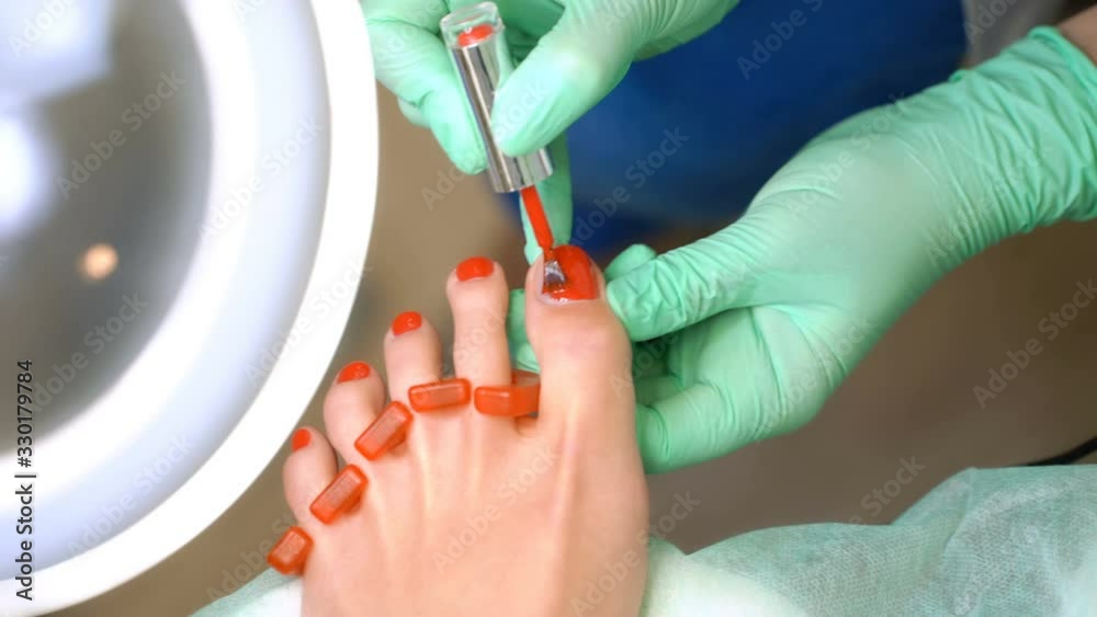 Pedicure master making aesthetic pedicure in a beauty salon. A ...