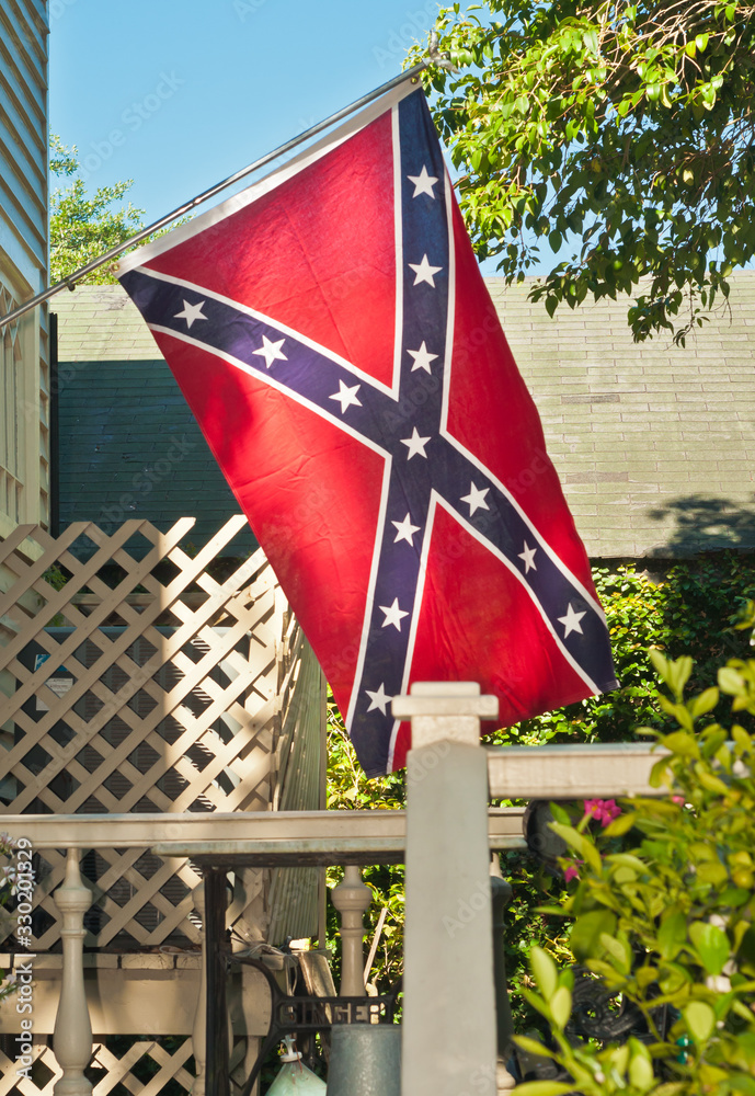 Front view of a confederate flag, flying from the back porch of an ...