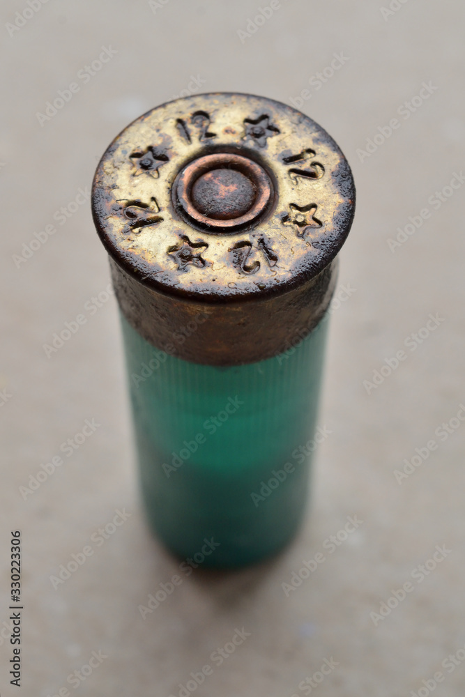 12 gauge slug cartridge for shotgubn with green plactic case and rusted ...