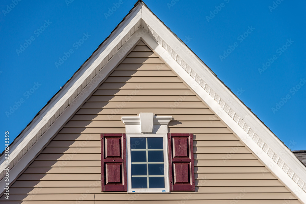 Gable with beige horizontal vinyl lap siding, double hung window with ...