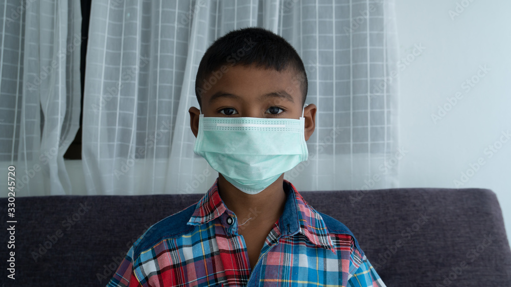 Cute little asian boy sick and wearing mask Stock Photo | Adobe Stock