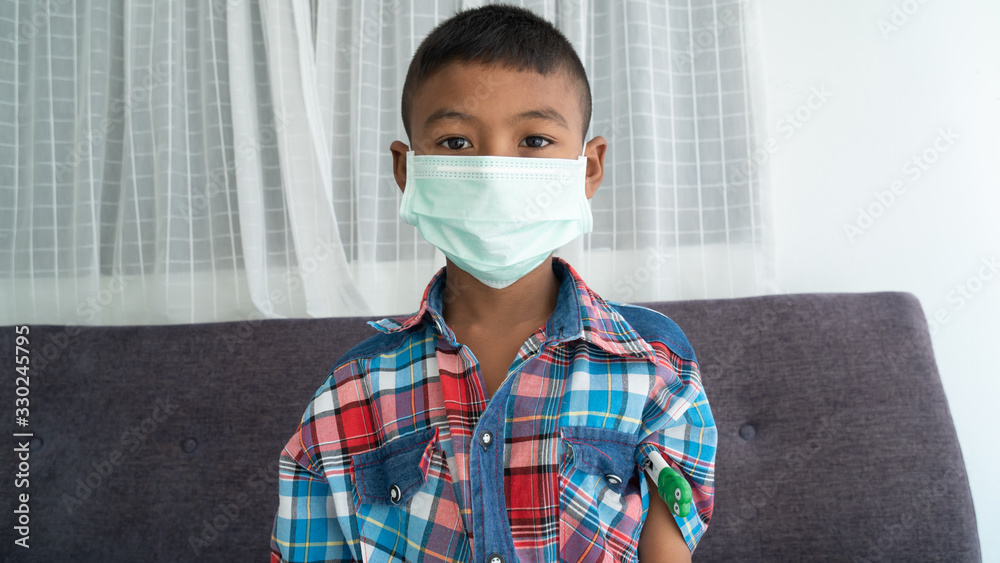 Cute little asian boy sick and wearing mask Stock Photo | Adobe Stock
