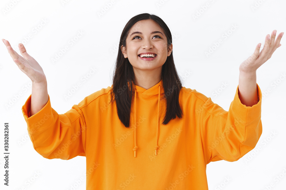 Girl catching something from sky. Cheerful happy asian woman raising ...