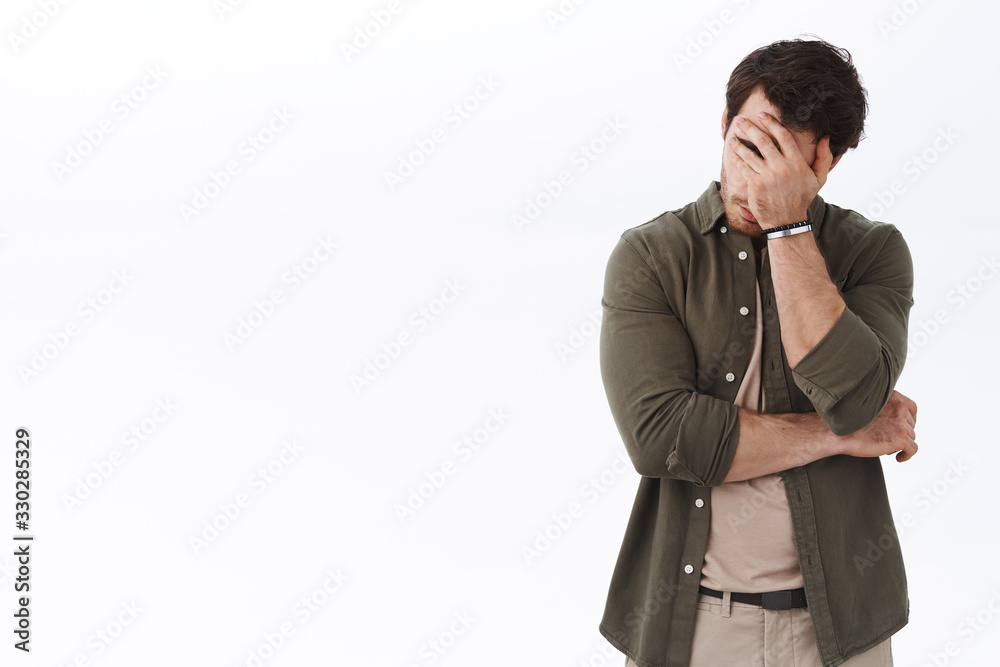 Annoyed and bothered caucasian handsome guy facepalm, low head and ...