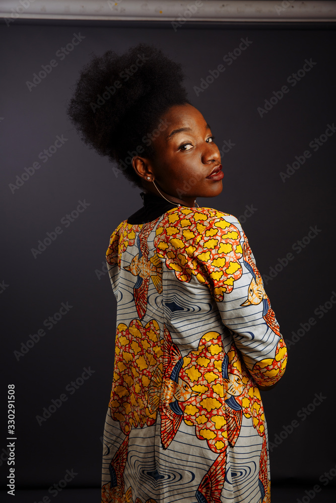 Beautiful African girl with a stunning hairstyle in a national costume ...