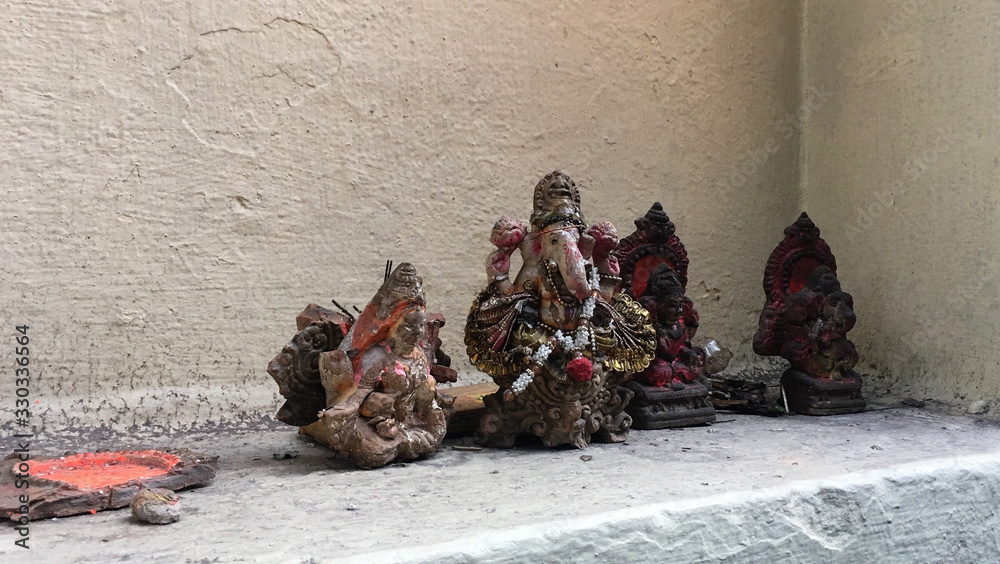 Tiny hindu gods on the wall at street, discovered culture on the corner ...